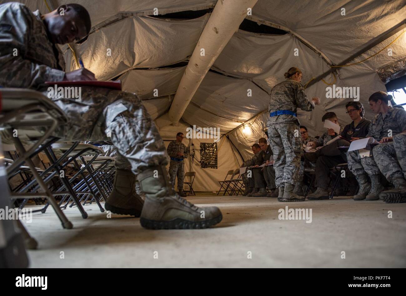 Airmen fill out in-processing paperwork at the beginning of a base ...