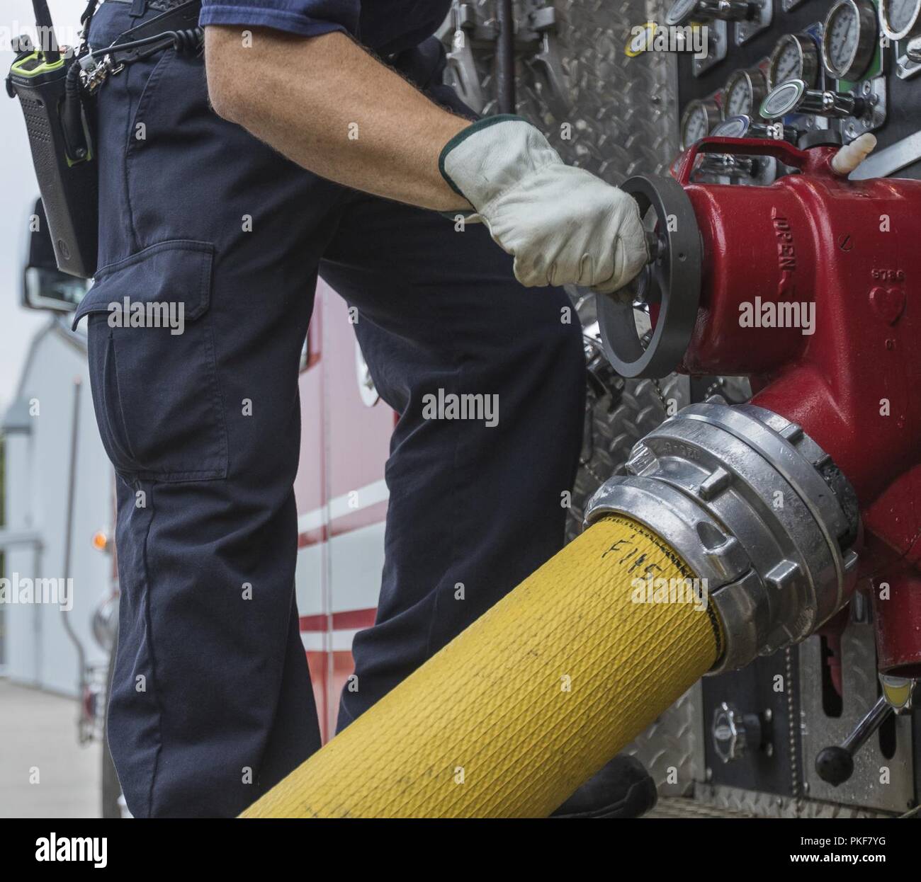 A firefighter cuts pressure to the engine's pump during a structural ...