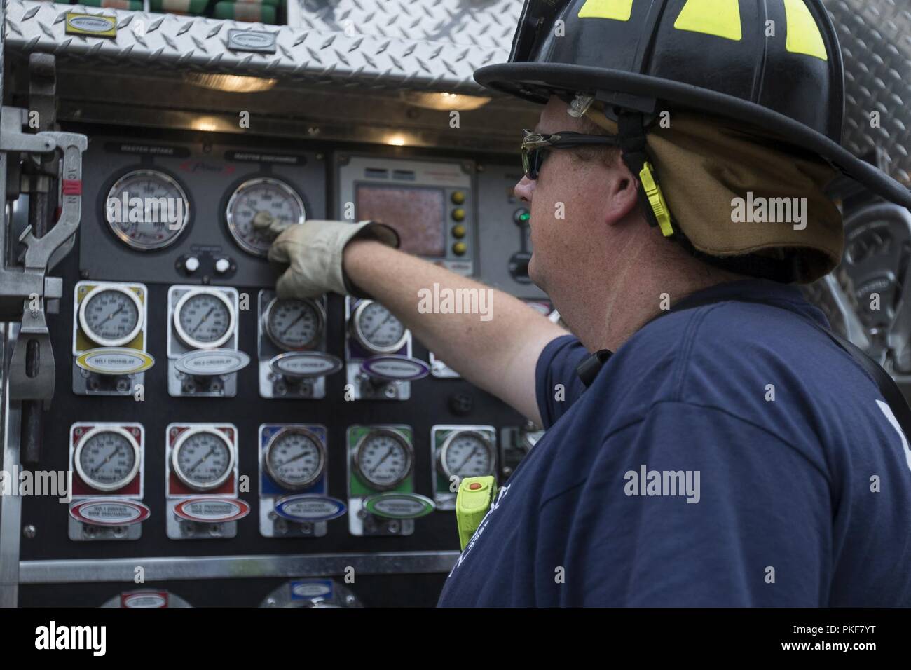 A firefighter monitors pump pressure during a structural fire drill ...
