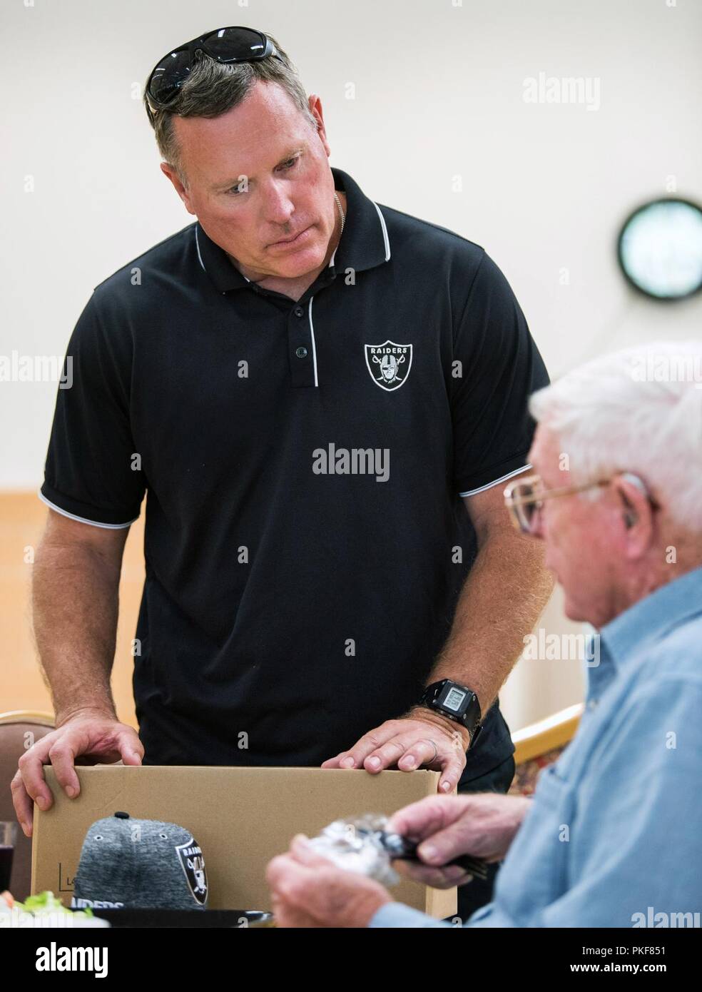 Raiders Alumni player Vance Mueller talks with a veteran during his ...