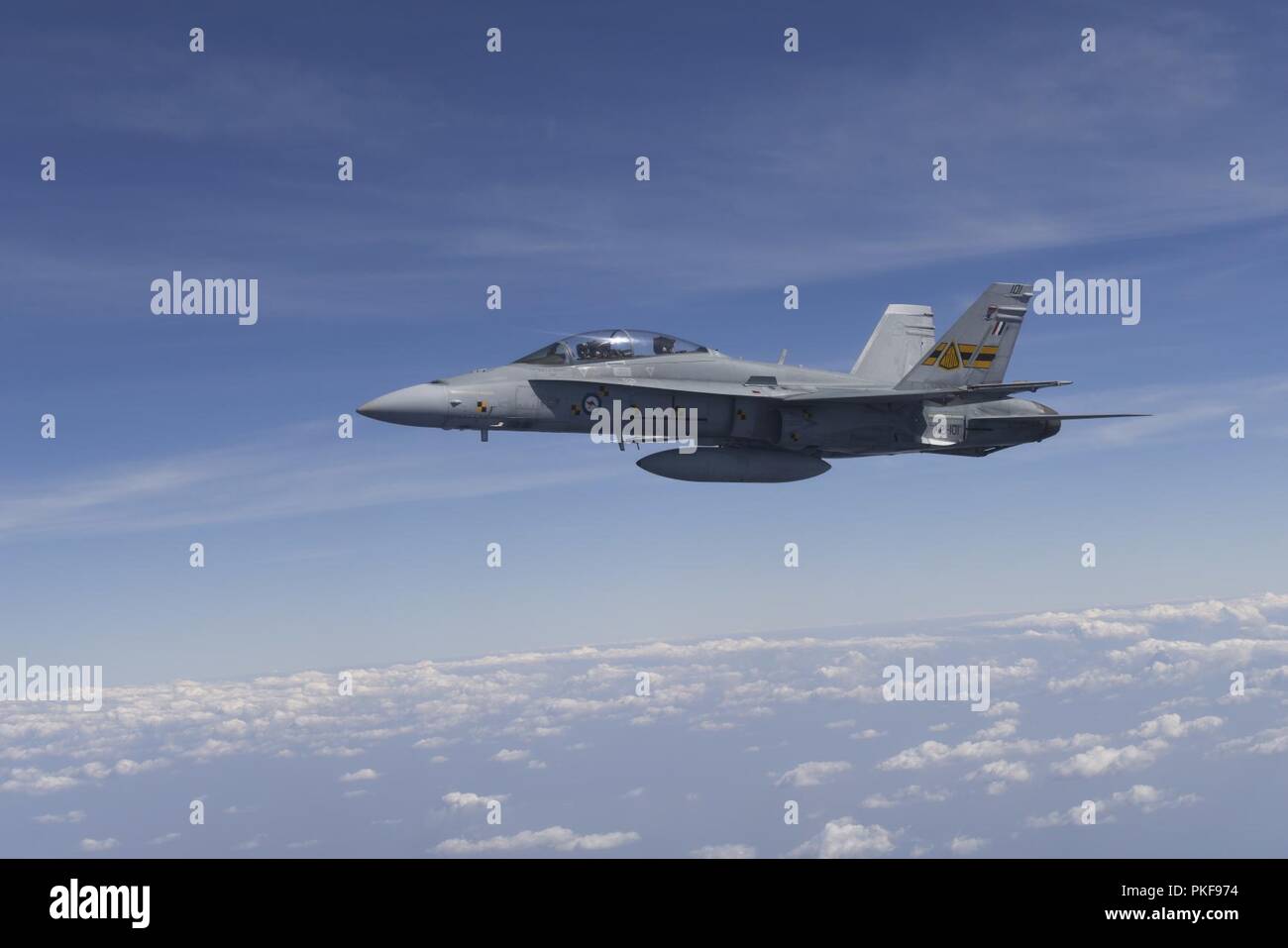 A Royal Australian Air Force F-18 Hornet approach a Royal Australian ...