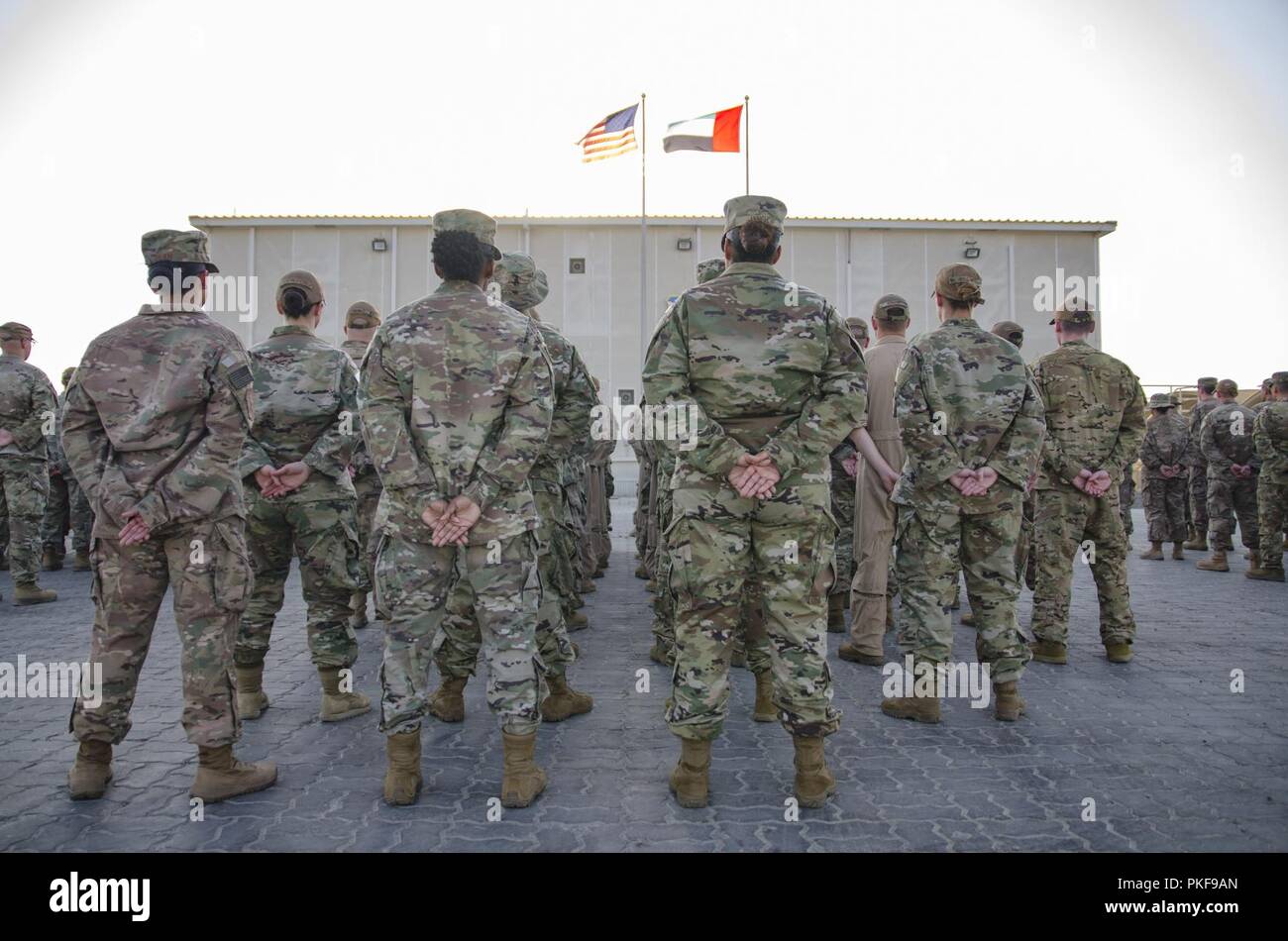 Servicemembers stand at parade rest during a retreat ceremony at Al ...