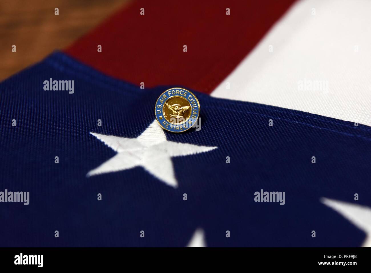 An Air Force civilian retirement pin is presented to Patricia Speights ...