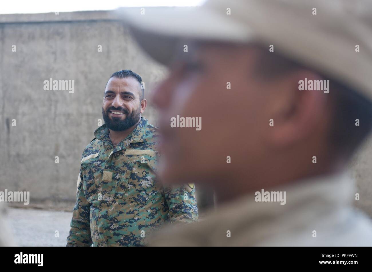 A Syrian Democratic Forces instructor oversees a recruit screening near ...