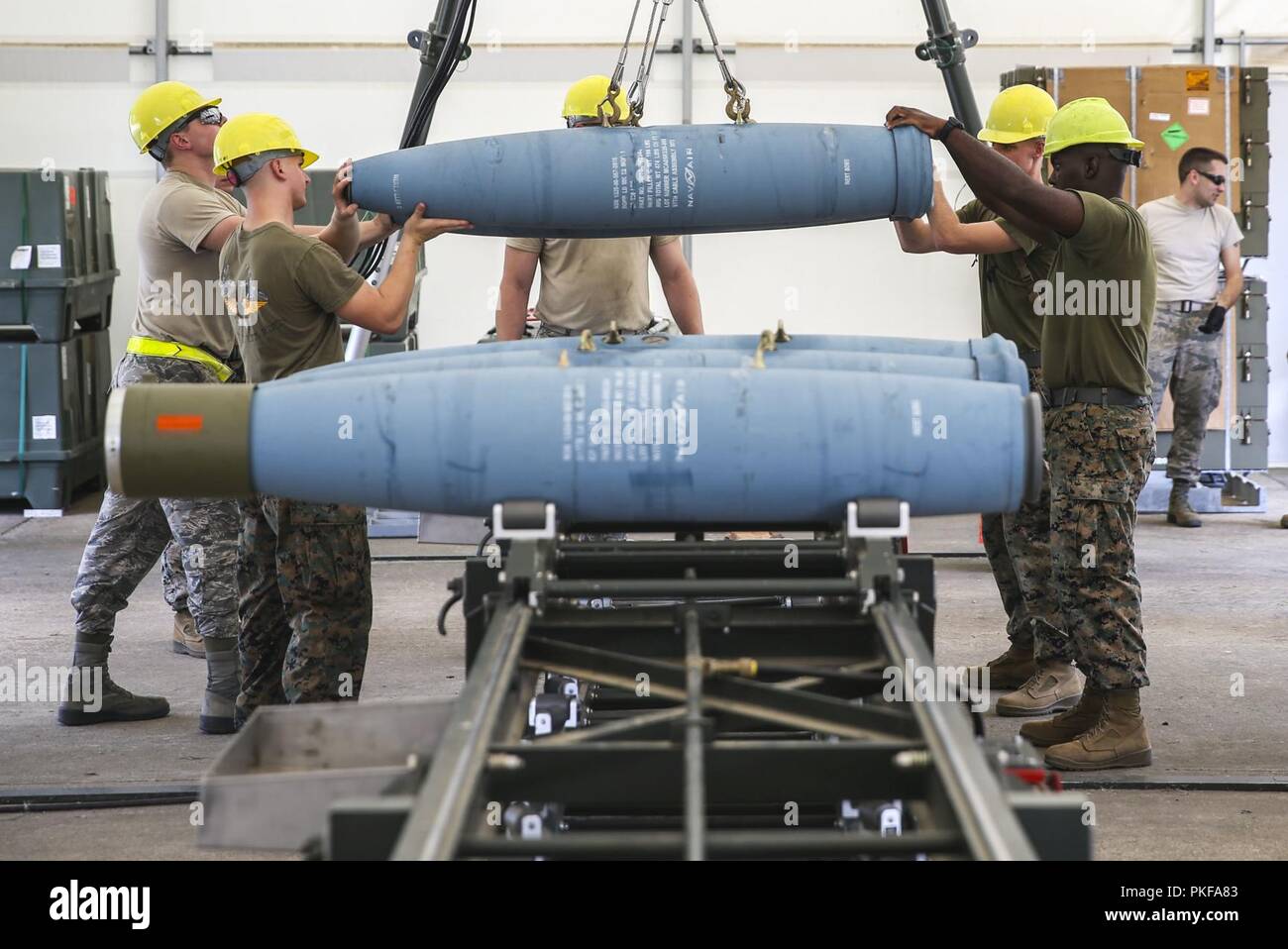 U.S. Marine ordnance technicians work with U.S. Air force ammo ...