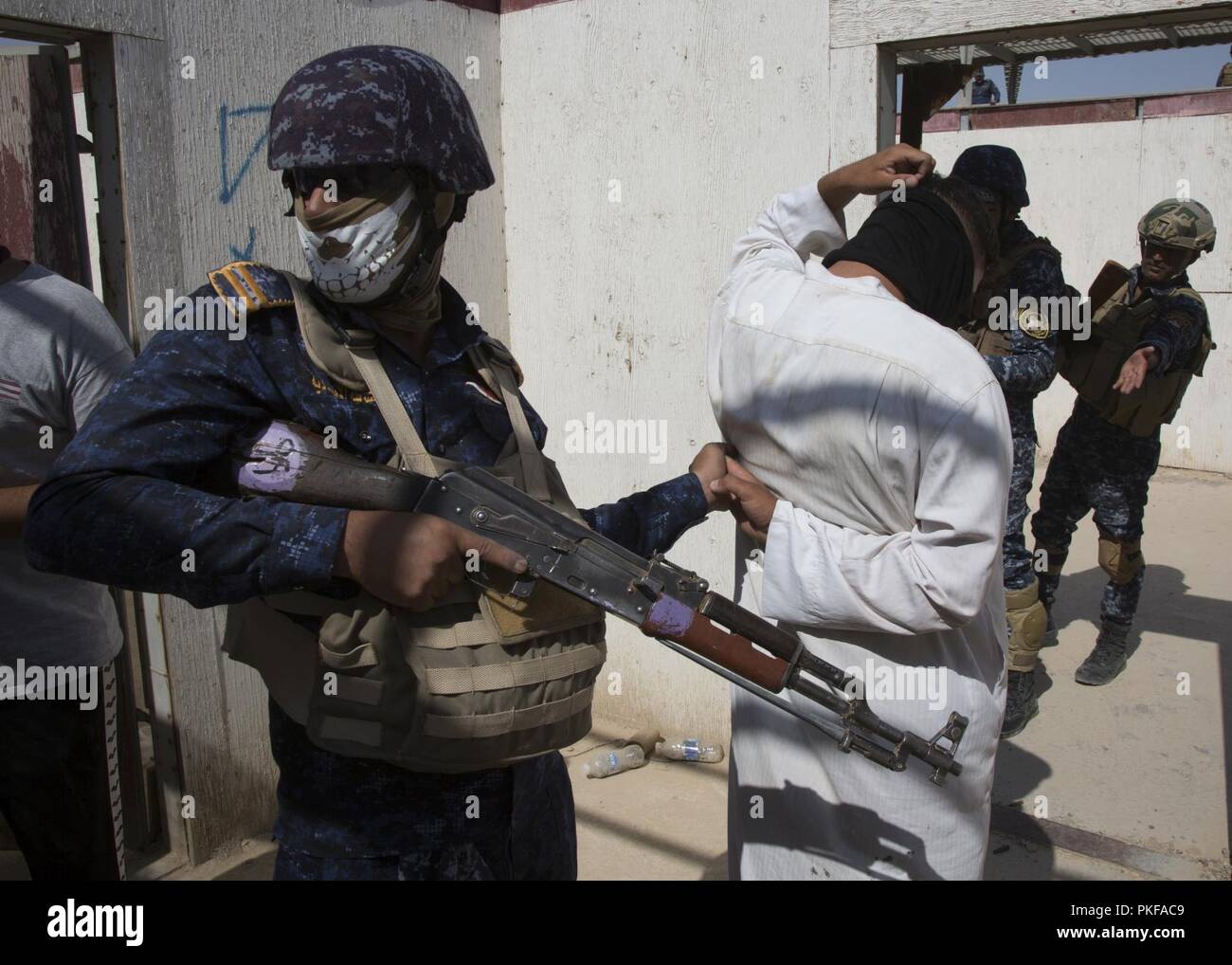A member of the Iraq Federal Police with the 13th Brigade, practices ...