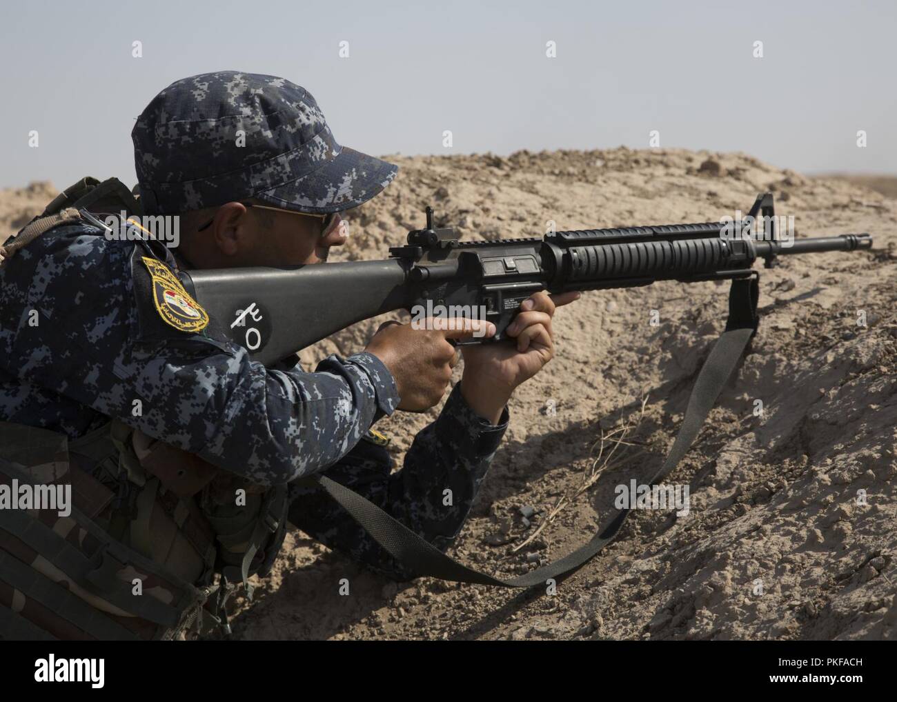A Member of the Iraq Federal Police with the 13th Brigade, practices an ...