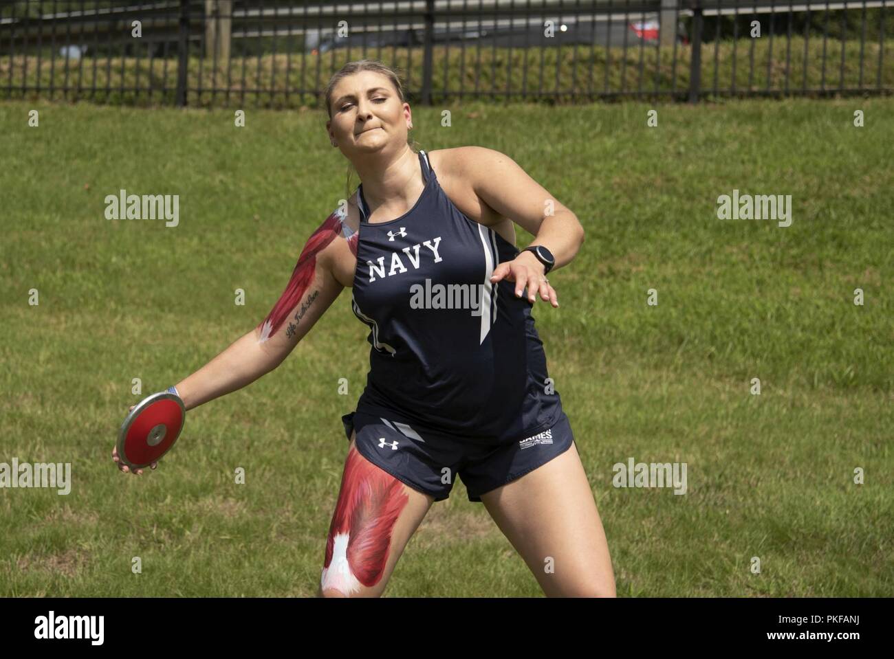 Navy Intelligence Specialist Cassidy Busch demonstrates by throwing a ...