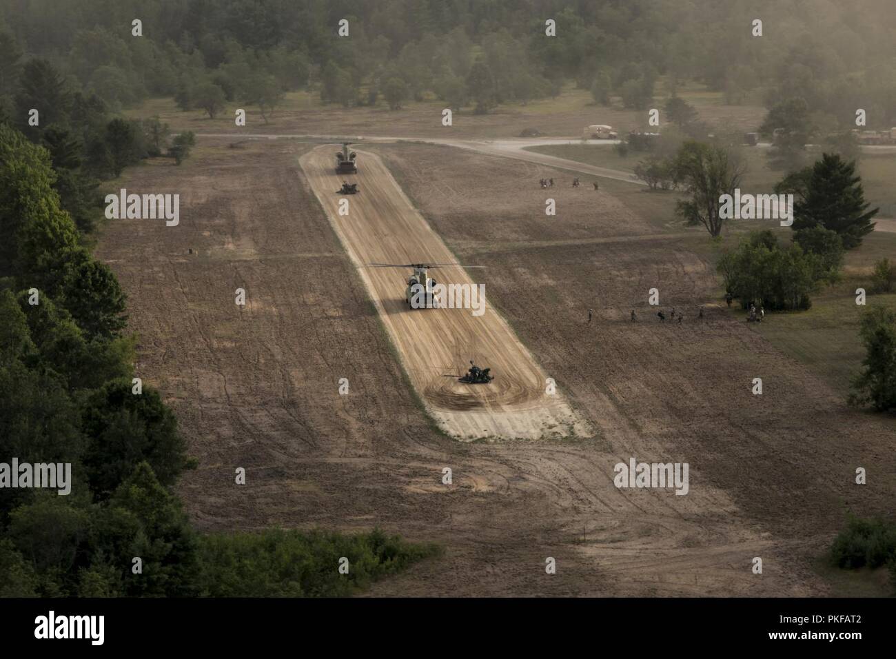 U.S. Army CH-47 Chinooks prepare for lift off after sling loading an ...