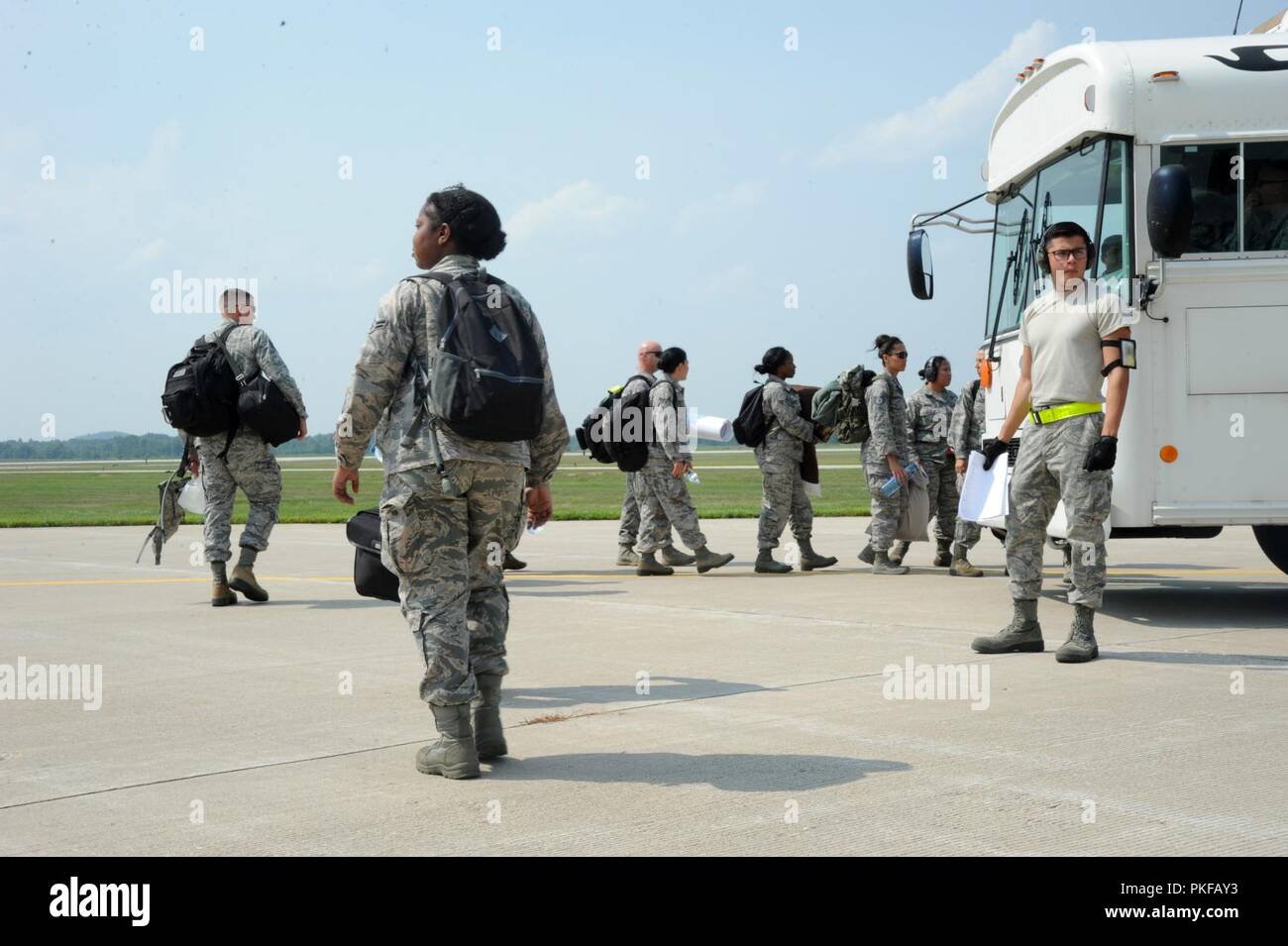 Members of the 927th Aeromedical Staging Squadron walk toward the bus ...
