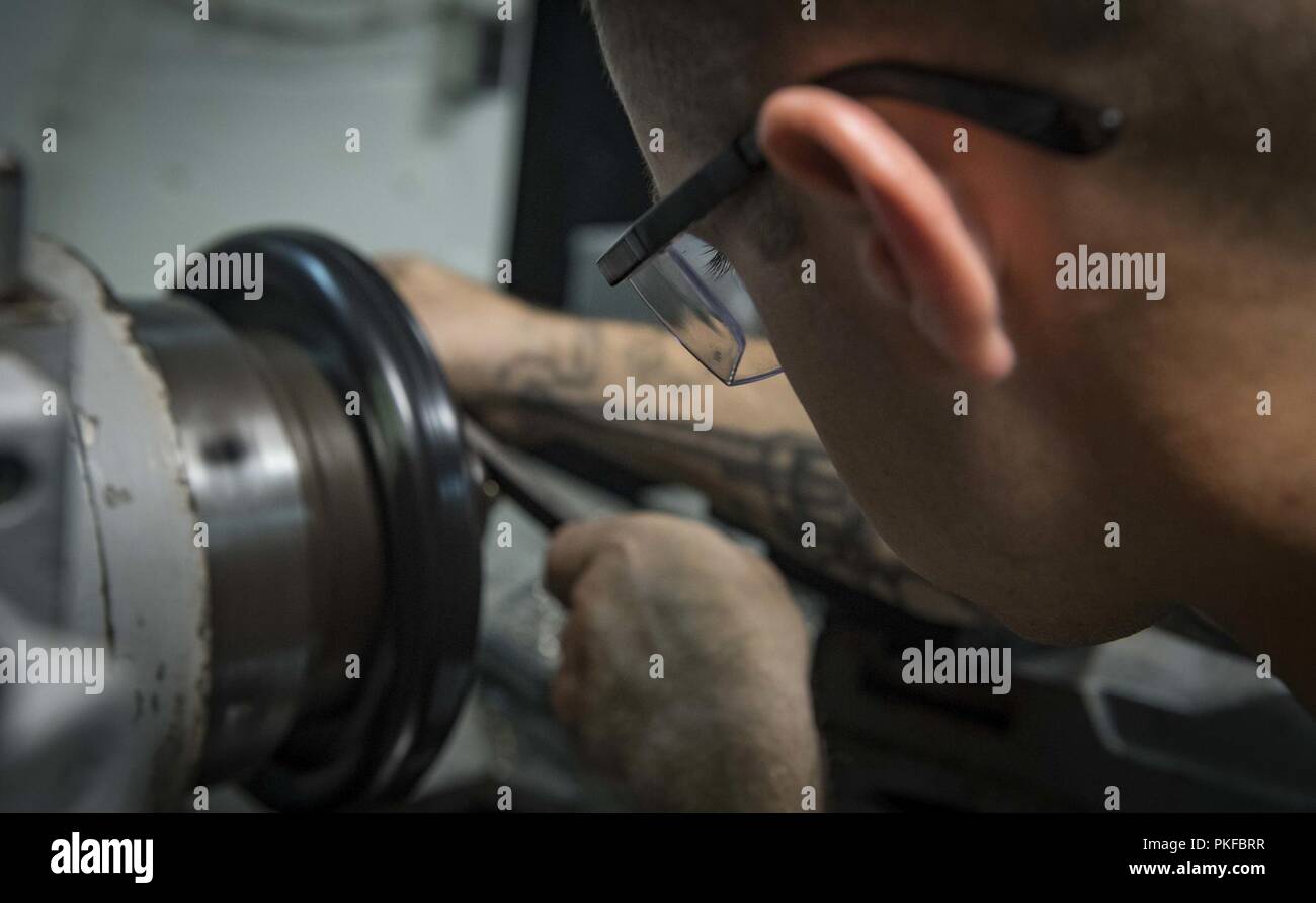 SEA (Aug. 9, 2018) Machinery Repairman 1st Class Michael Gilder uses a ...