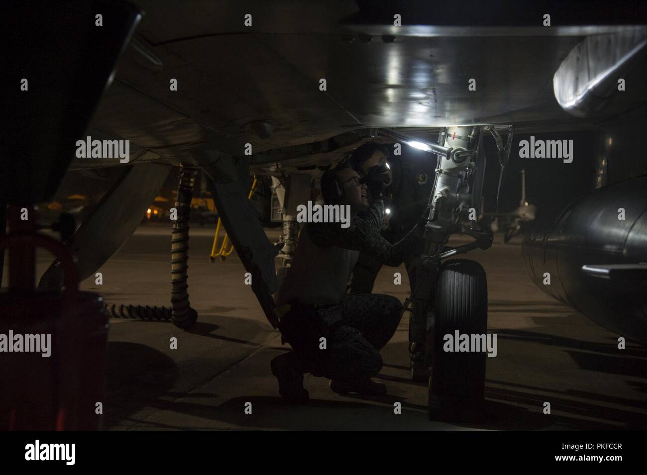 A Colombian Air Force Kfir fighter jet’s crew chief and pilot conduct a ...
