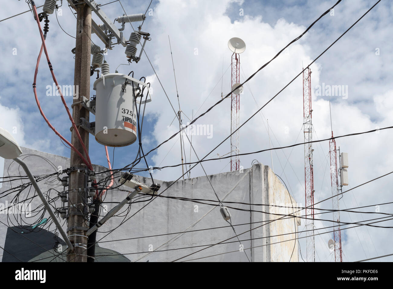 Street electric cables on a pole with satellite dishes and radio ...