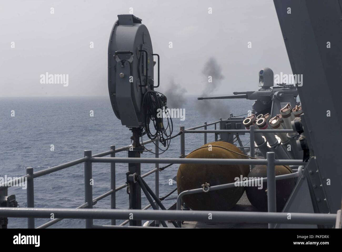 PACIFIC OCEAN (Aug. 13, 2018) – The MK38 25-mm machine gun system is fired from Whidbey Island ...