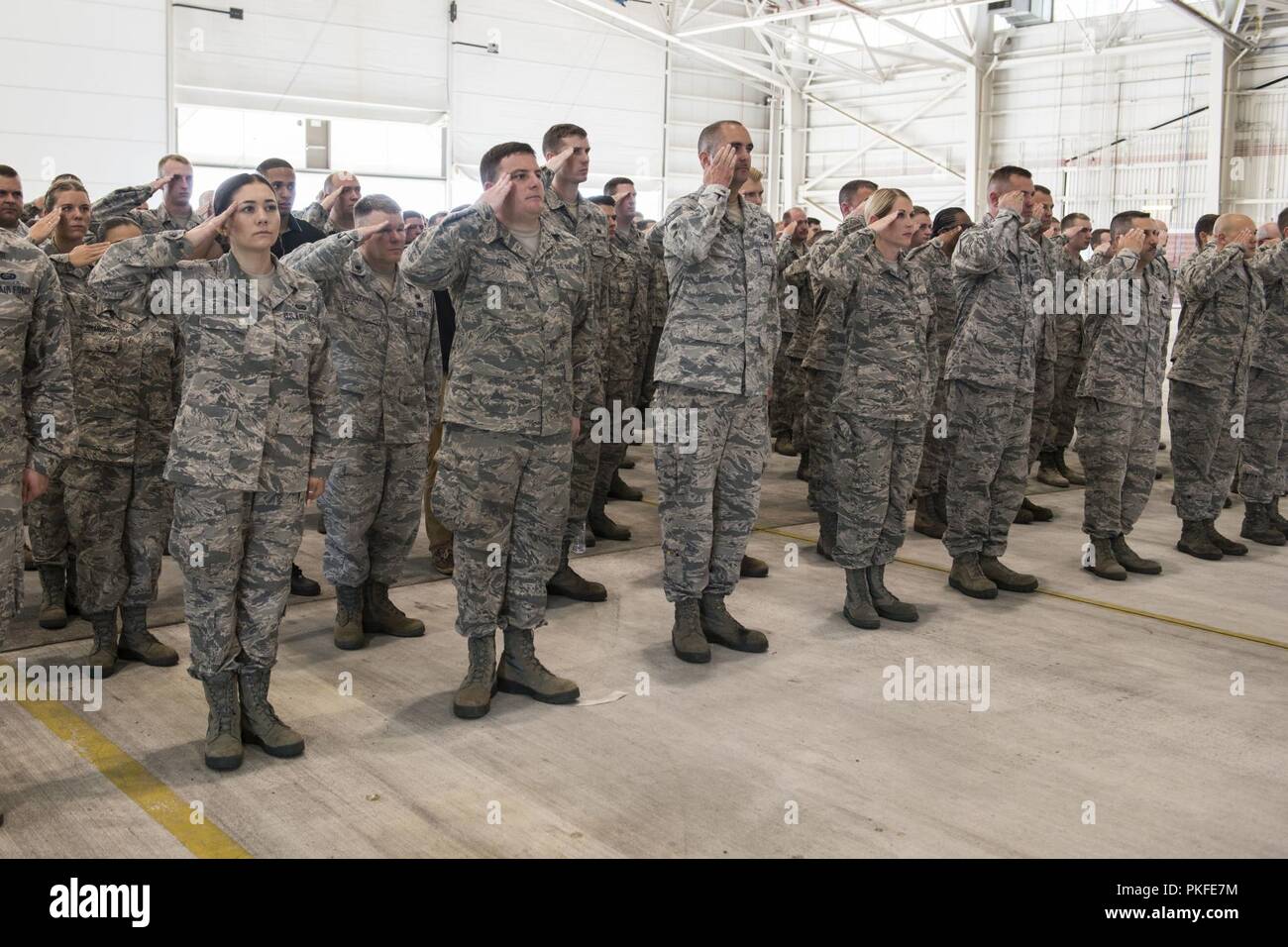 Airmen render a salute to incoming wing commander Col. David Cochran ...