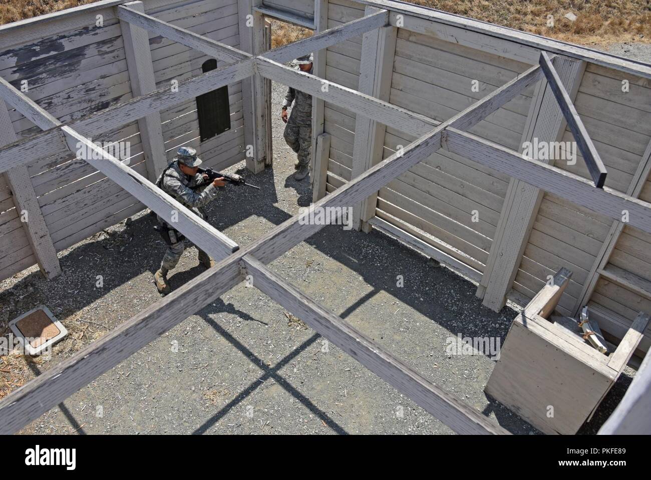 A U.S. Air National Guardsman fires M4 Simunition rounds into a target ...