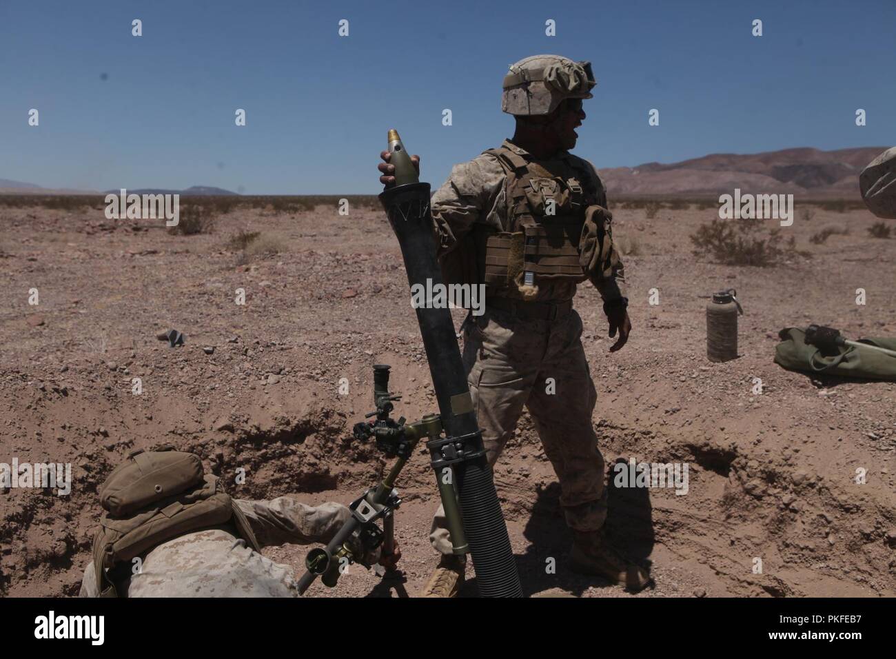 A U.S. Marine with 3rd Battalion, 6th Marine Regiment drops a round in ...