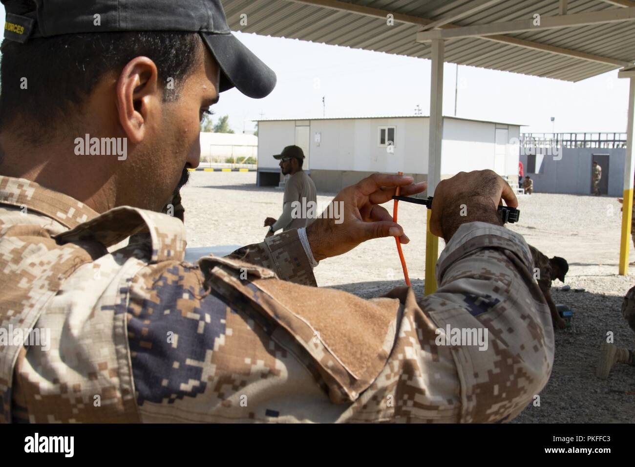 A member of the Iraqi Counter Terrorism Service prepares detonation ...