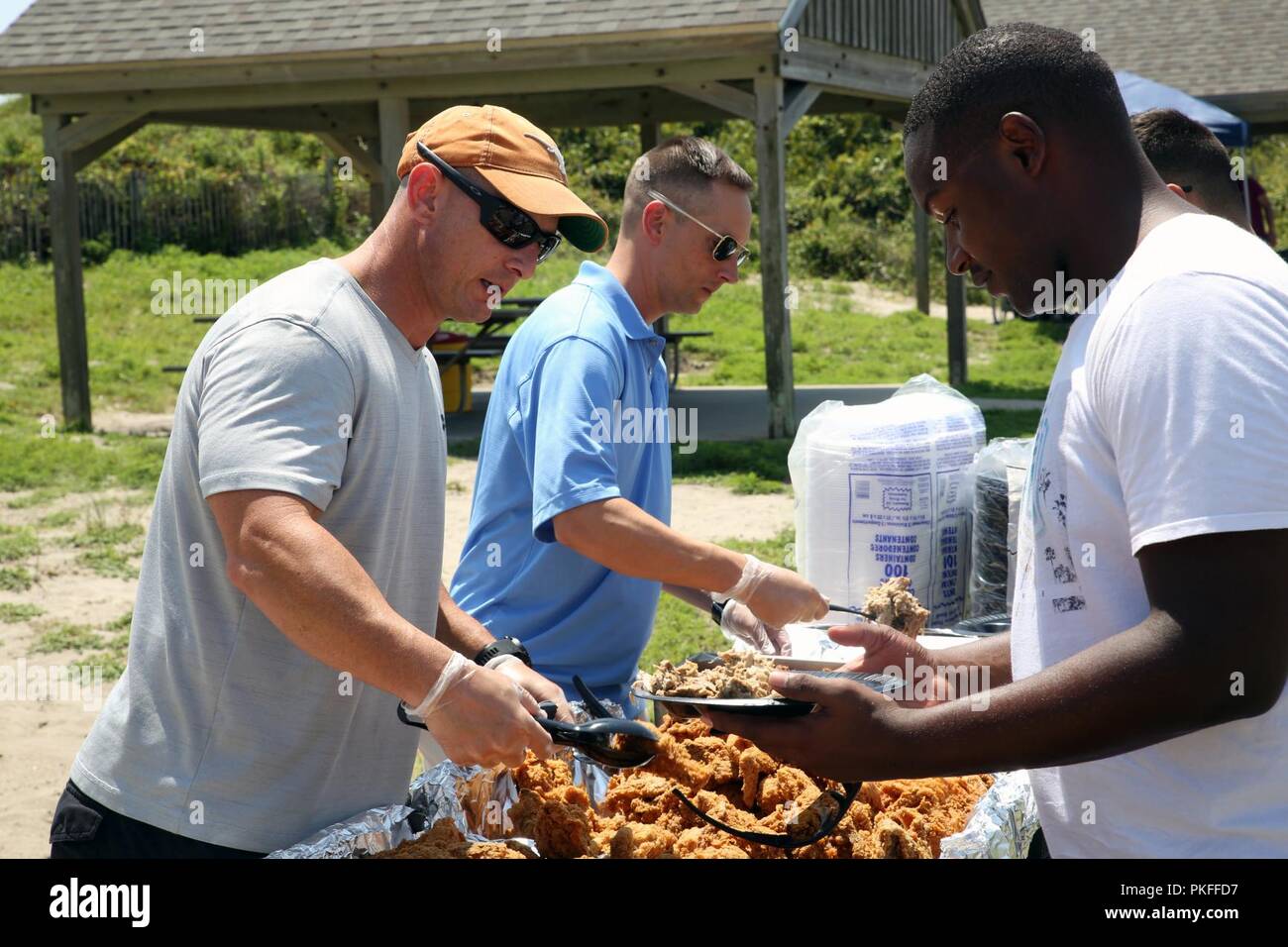 Sgt. Maj. Christopher Davis, left, serves food to a Marine during the ...