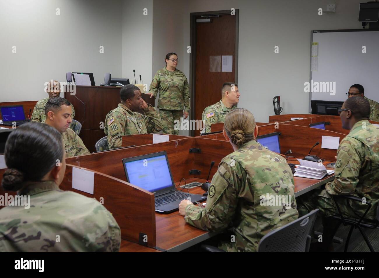 Sgt. 1st Class Brooke Crytser (standing center), an assistant ...