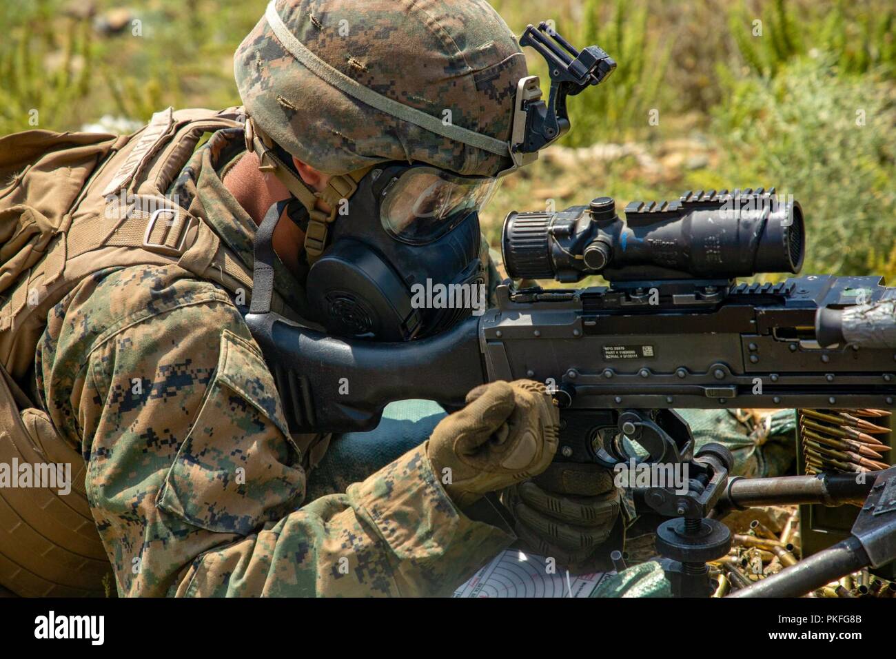 A U.S. Marine with Black Sea Rotational Force 18.1 reloads an M240B ...