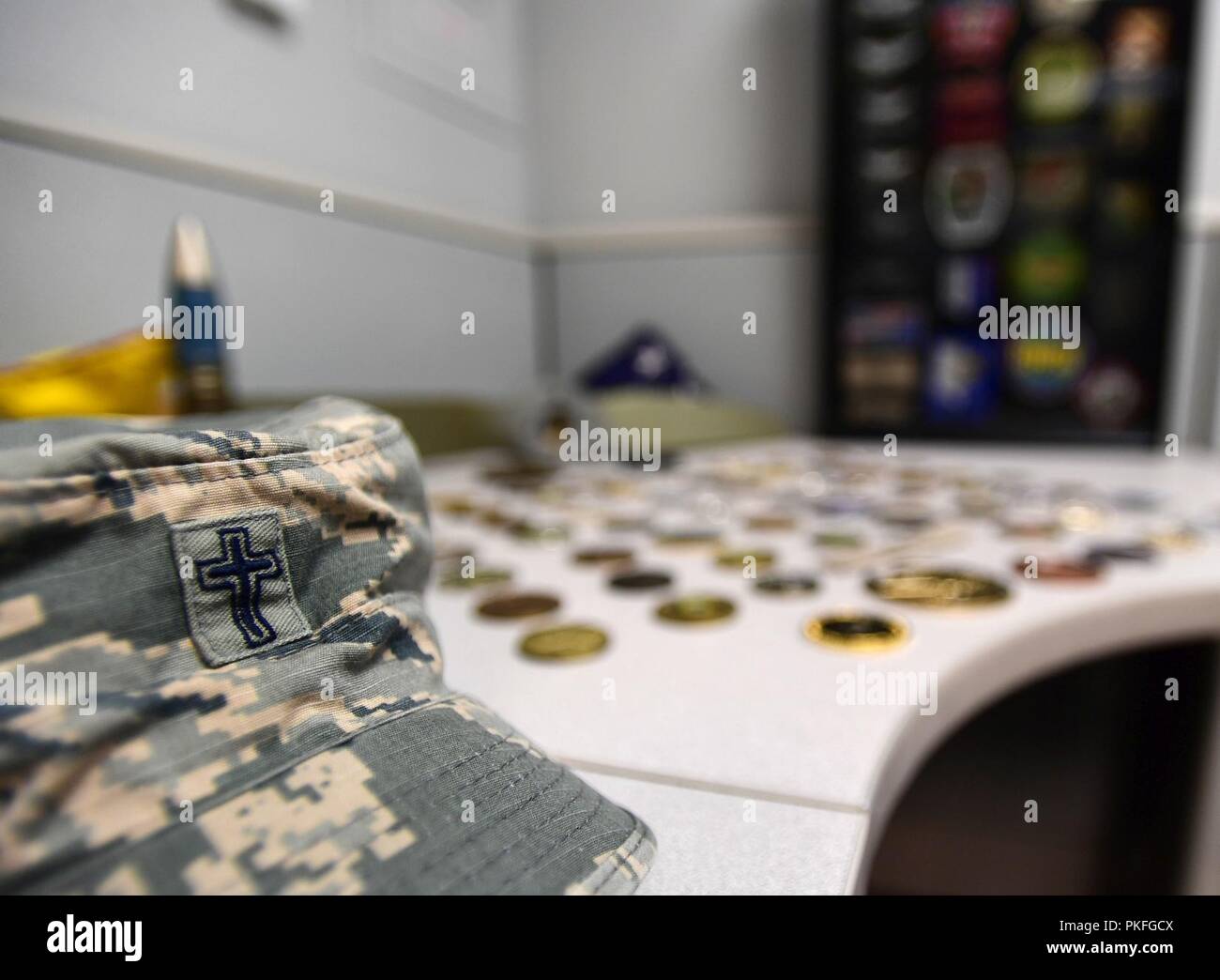 Chaplain Matthew’s hat sits alongside his military coins and patches ...