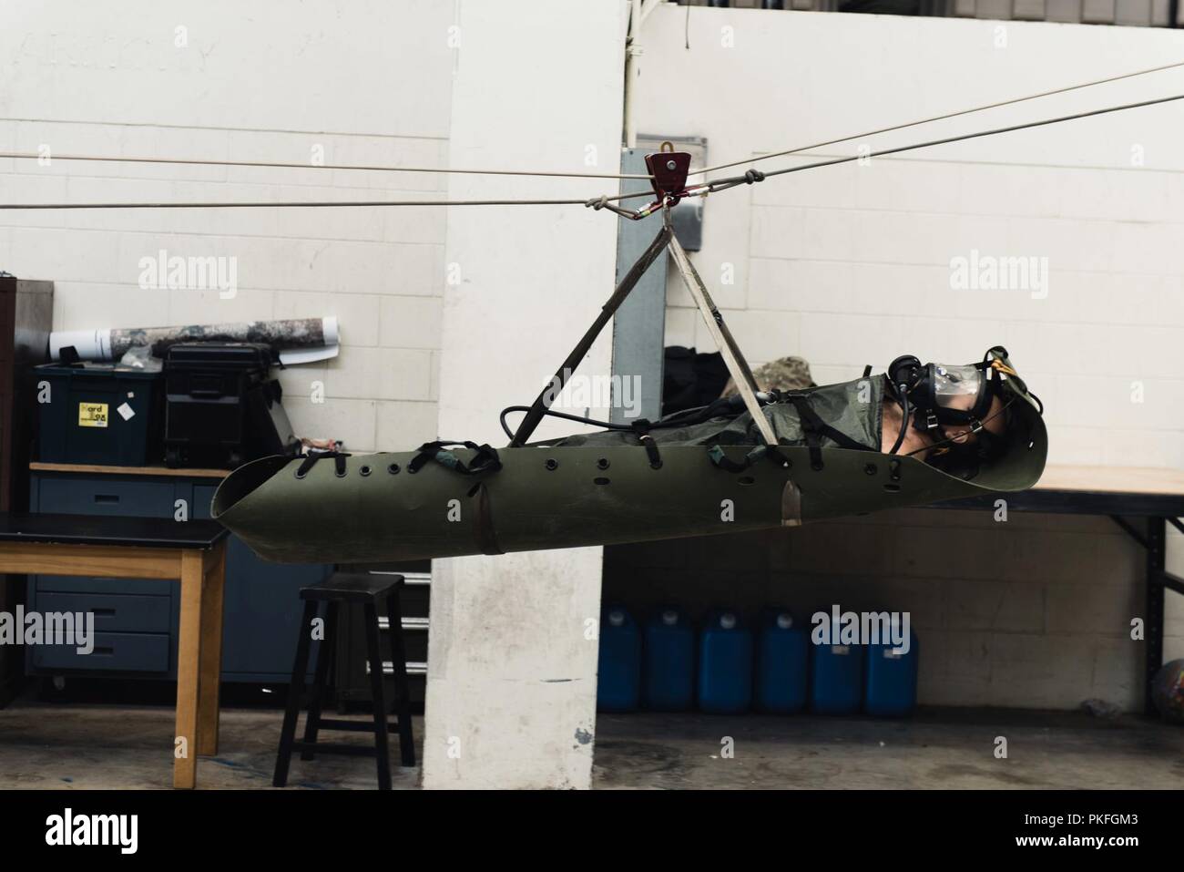 A weighted training dummy is slowly lowered to pararescuemen from the ...