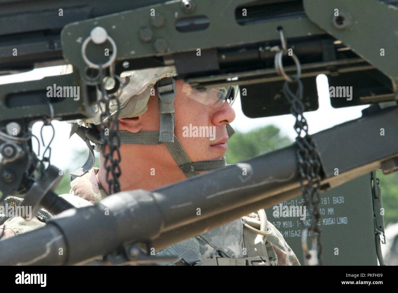 A U.S. Army Reserve Soldier preforming as an assistant gunner, watches ...