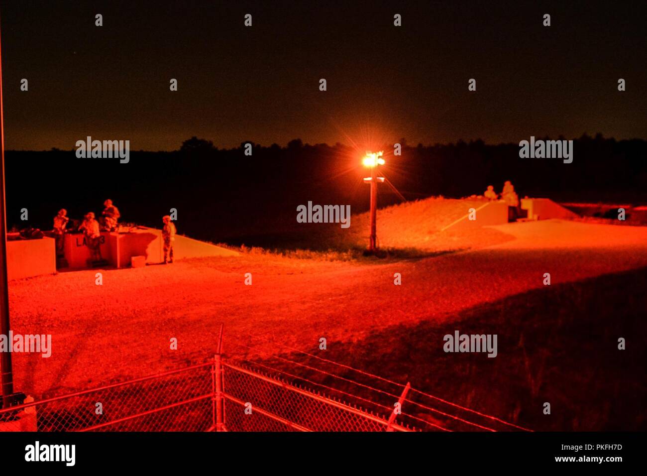 Red lights illuminate an M2 machine gun and Mark 19 40 mm grenade ...