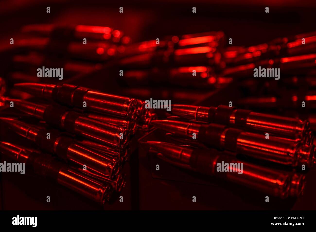 Ammunition is prepared and illuminated by red lights for night-fire ...