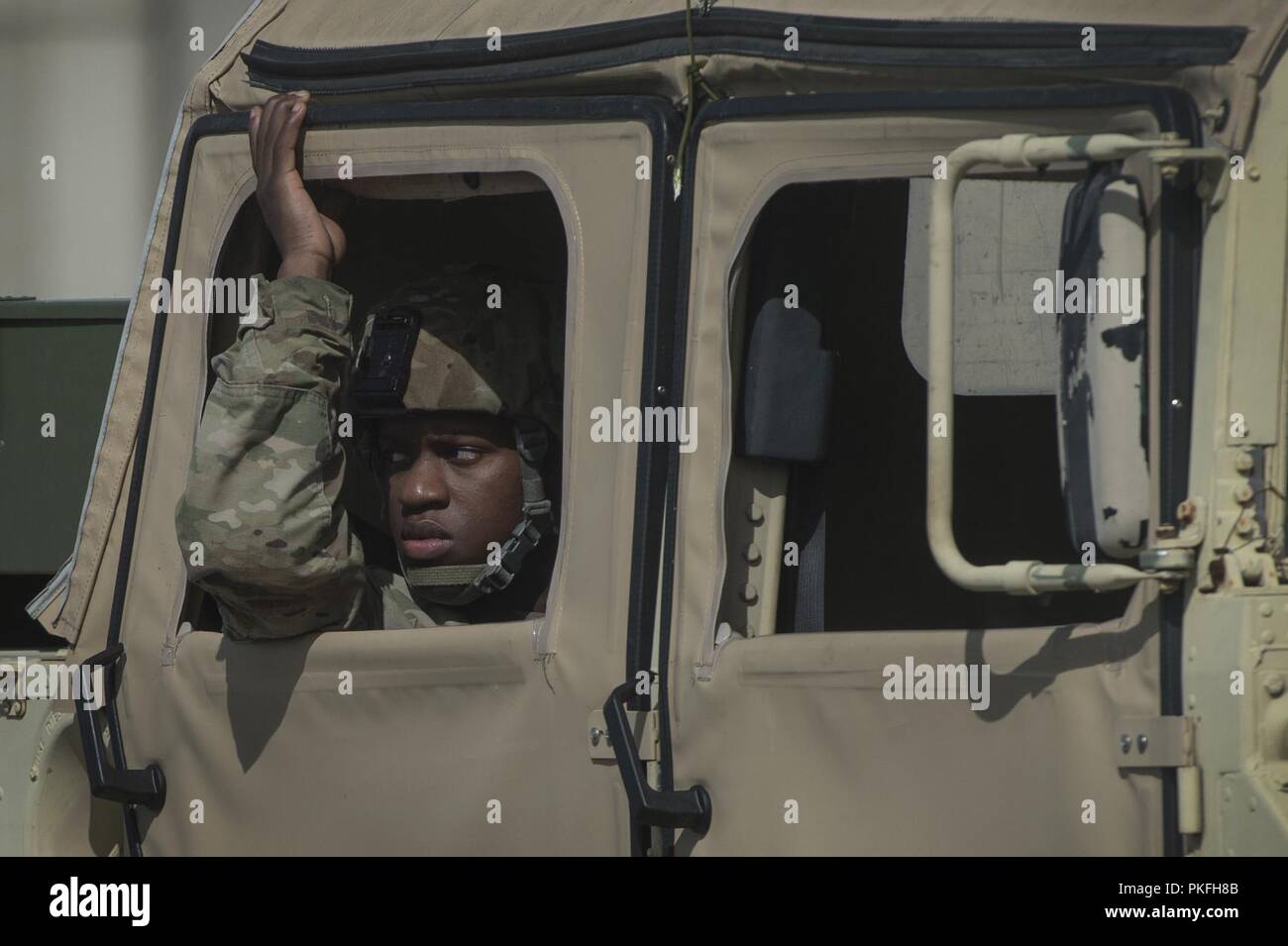 A U.S. Army Soldier looks out the window of a Humvee during rail ...