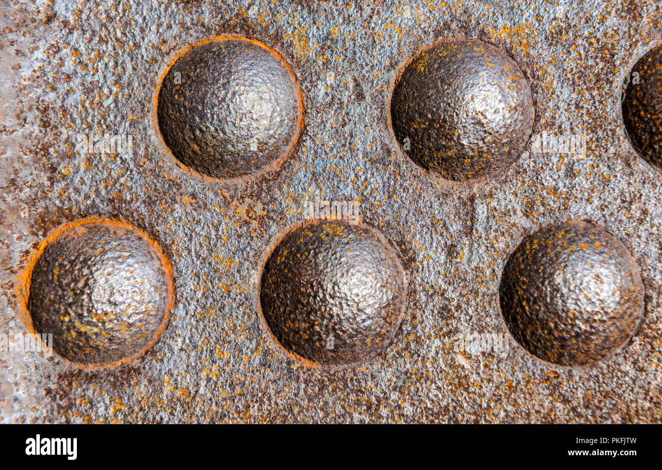 Close up detail of rusted metal texture and pattern of circular rivets ...