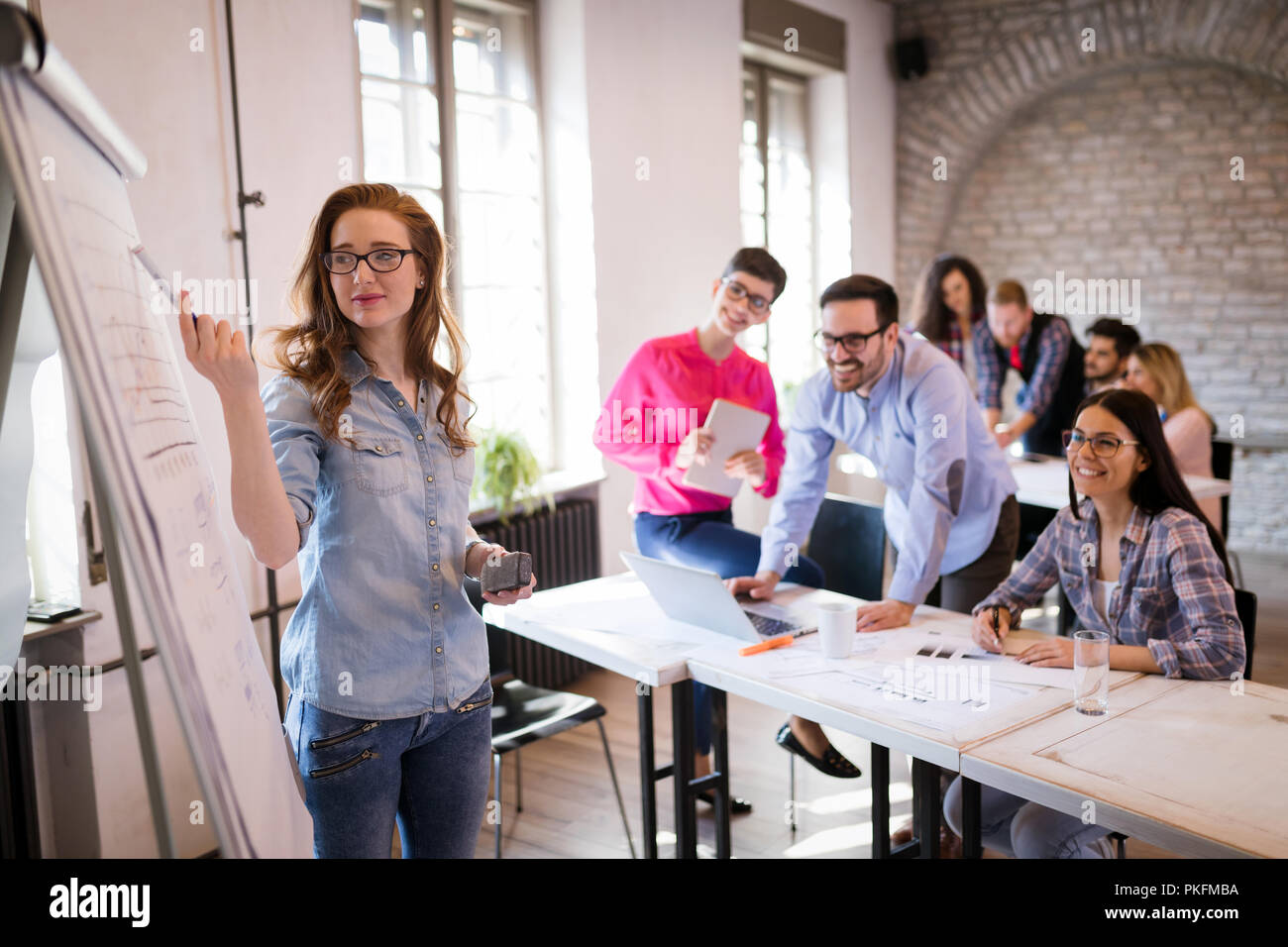 Portrait of young attractive architect doing presentation Stock Photo ...