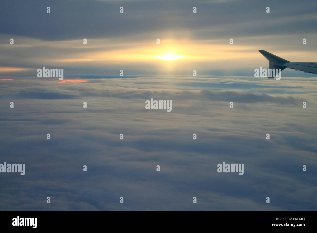 High Altitude Sunset over the Clouds from a Plane Window Stock Photo ...