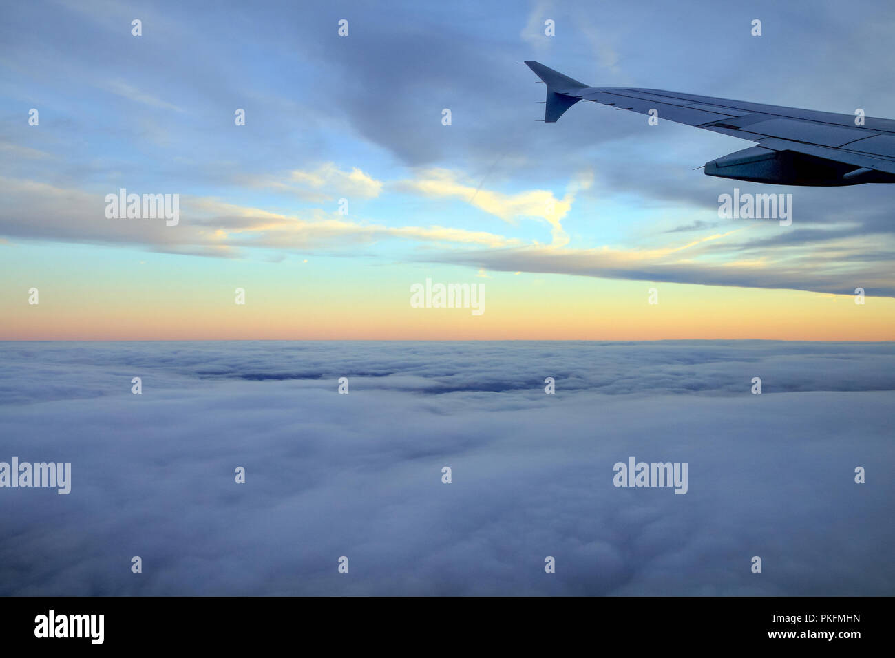 High Altitude Sunset over the Clouds from a Plane Window Stock Photo ...
