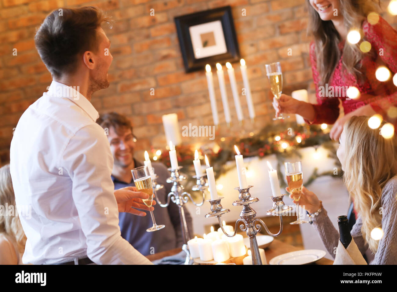 Celebration of Christmas in close group of friends Stock Photo - Alamy
