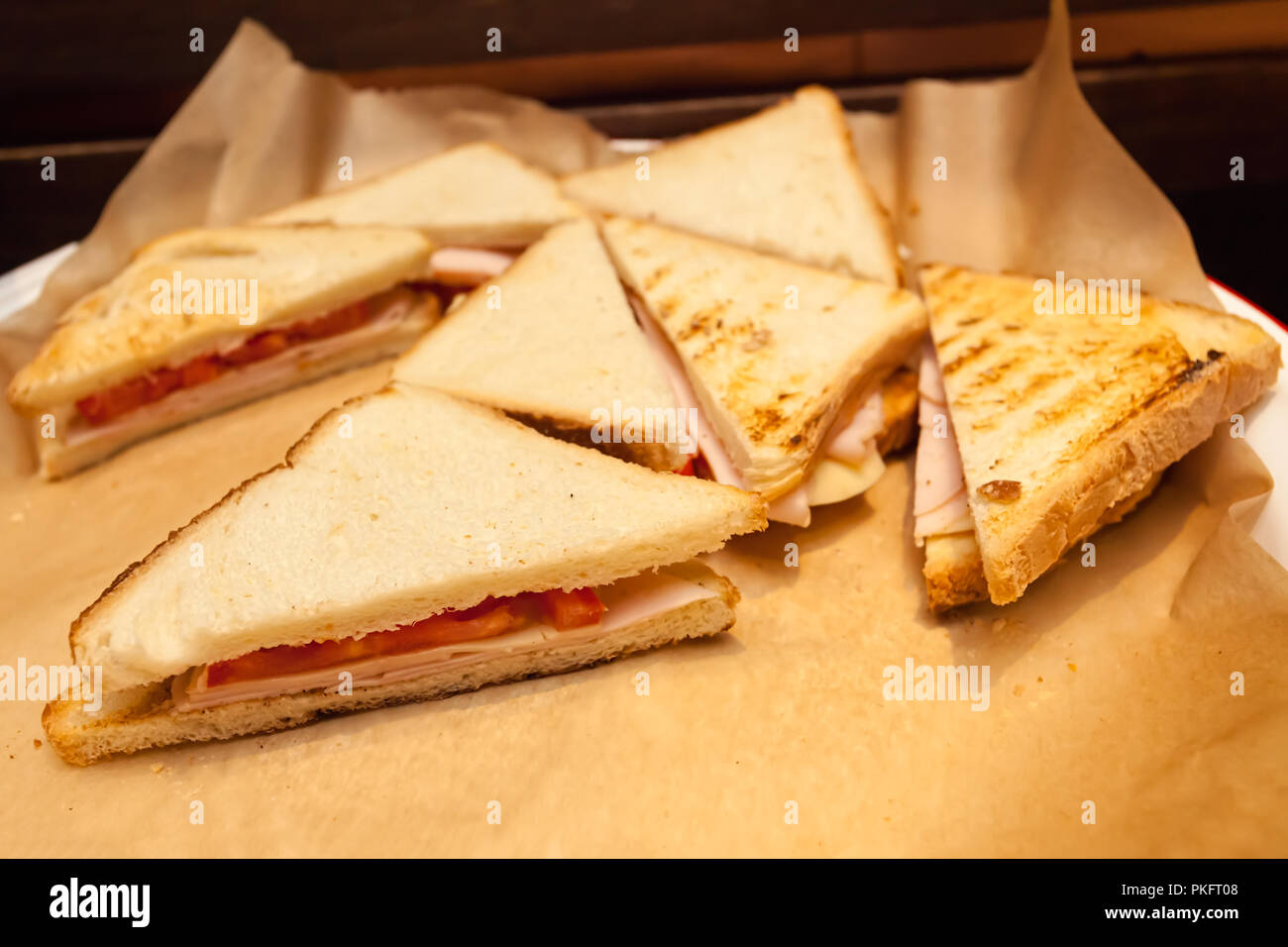 Top view, triangle shaped, toasted white bread club panini sandwiches ...
