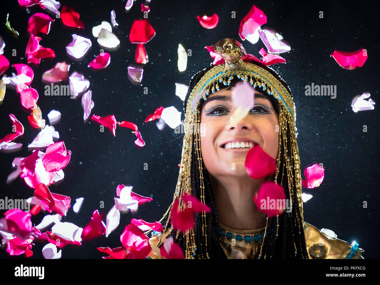 Model Jeshika Mullins dressed as Queen Cleopatra with falling rose ...