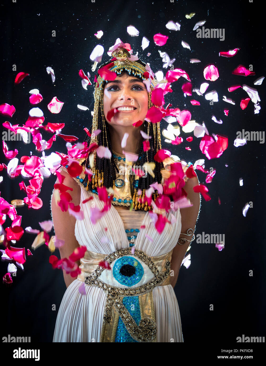 Model Jeshika Mullins dressed as Queen Cleopatra with falling rose ...