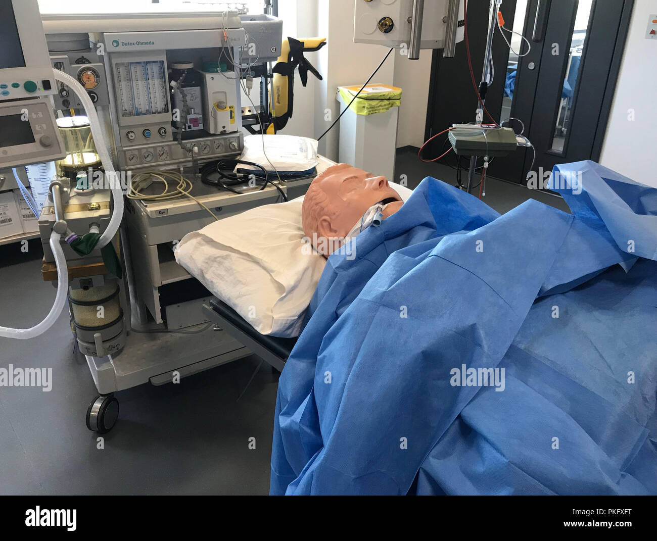An interactive dummy is used as a â'patient' on an operating table to ...