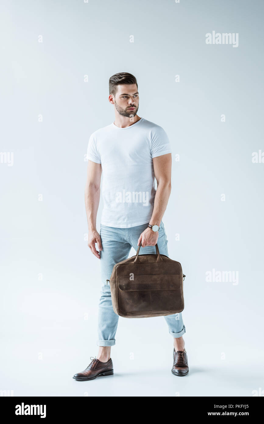 Stylish young man carrying briefcase on white background Stock Photo ...