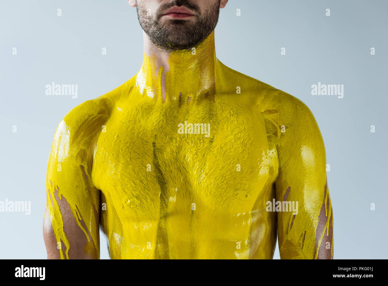 Male body stained with yellow paint isolated on white background Stock ...