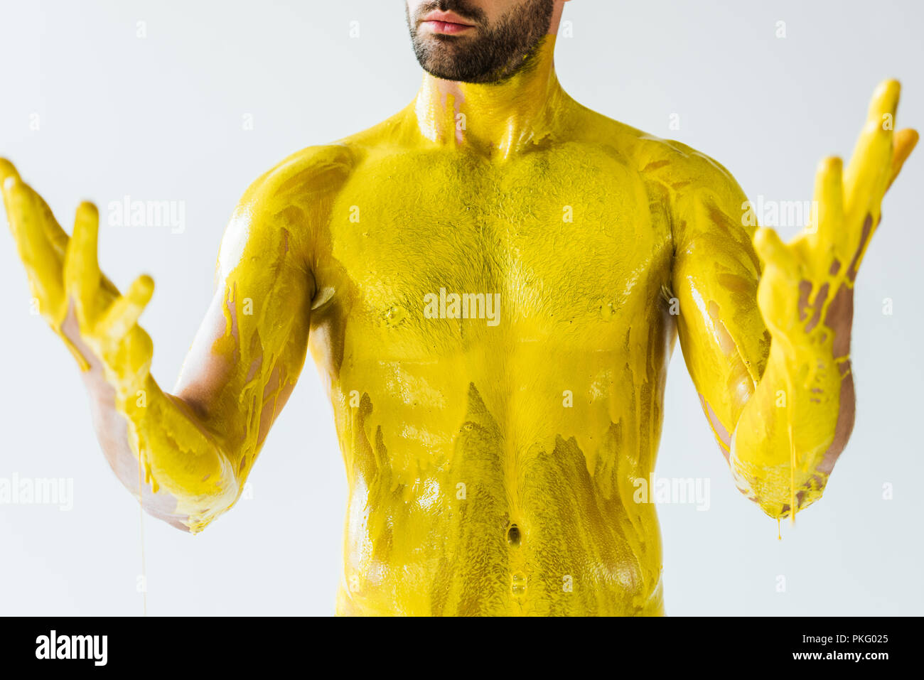 Male body and hands stained with yellow liquid isolated on white ...