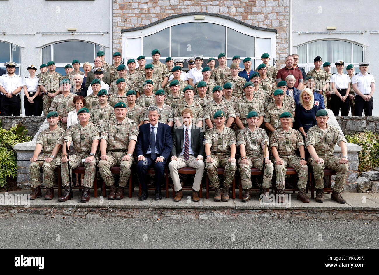 The Duke of Sussex poses for a group photo during a visit to the Royal ...