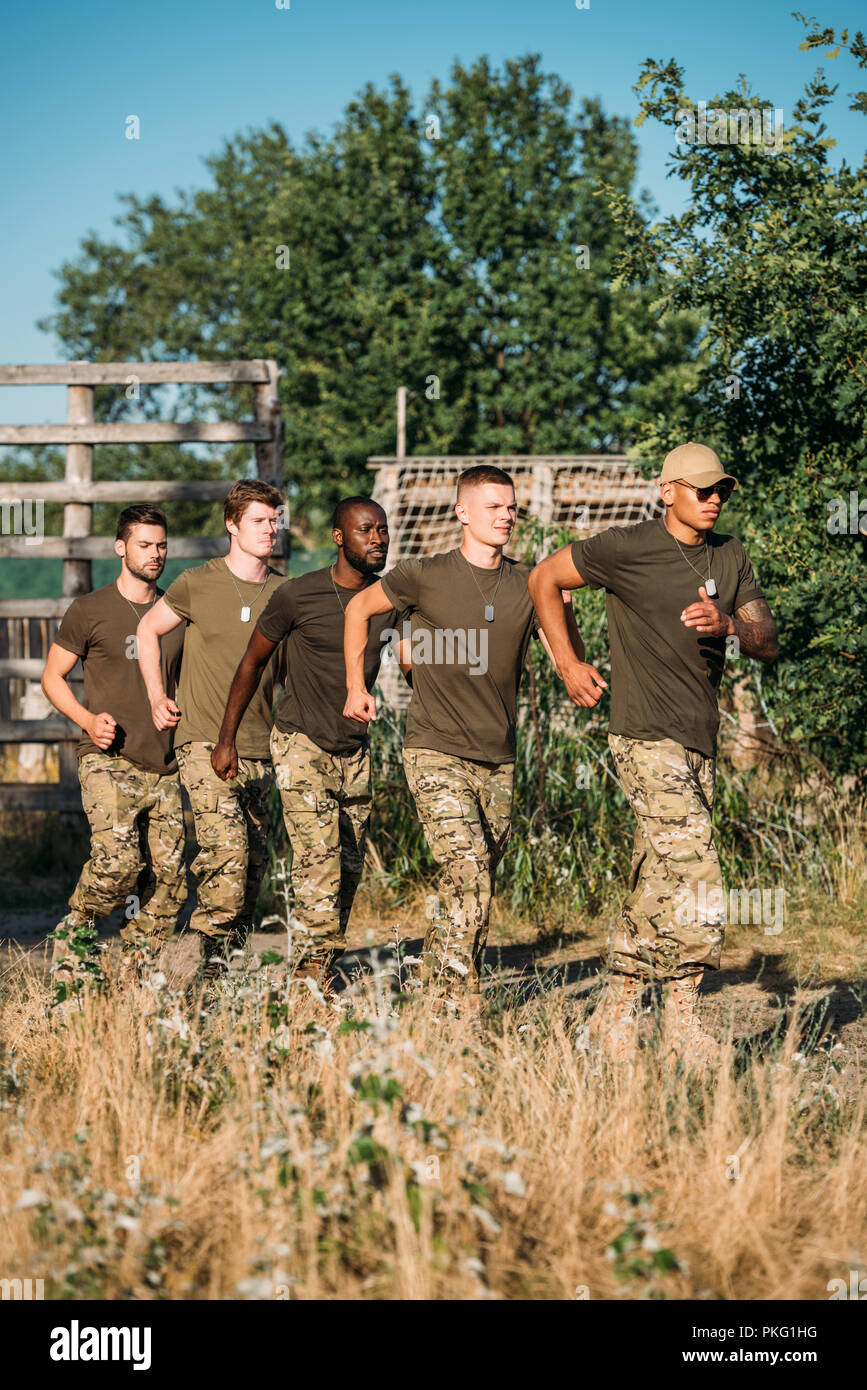 multiethnic soldiers in military uniform running on range Stock Photo ...