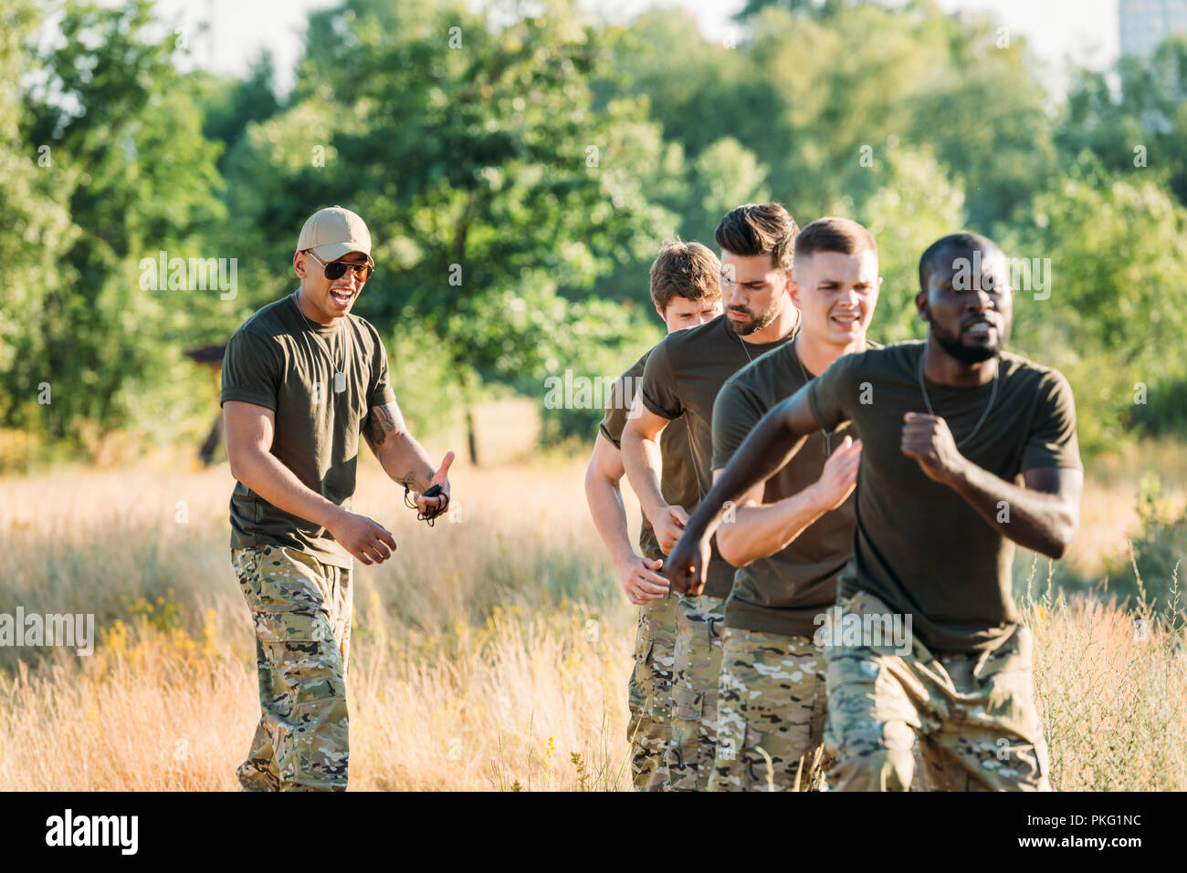 african american tactical instructor with stop watch examining ...