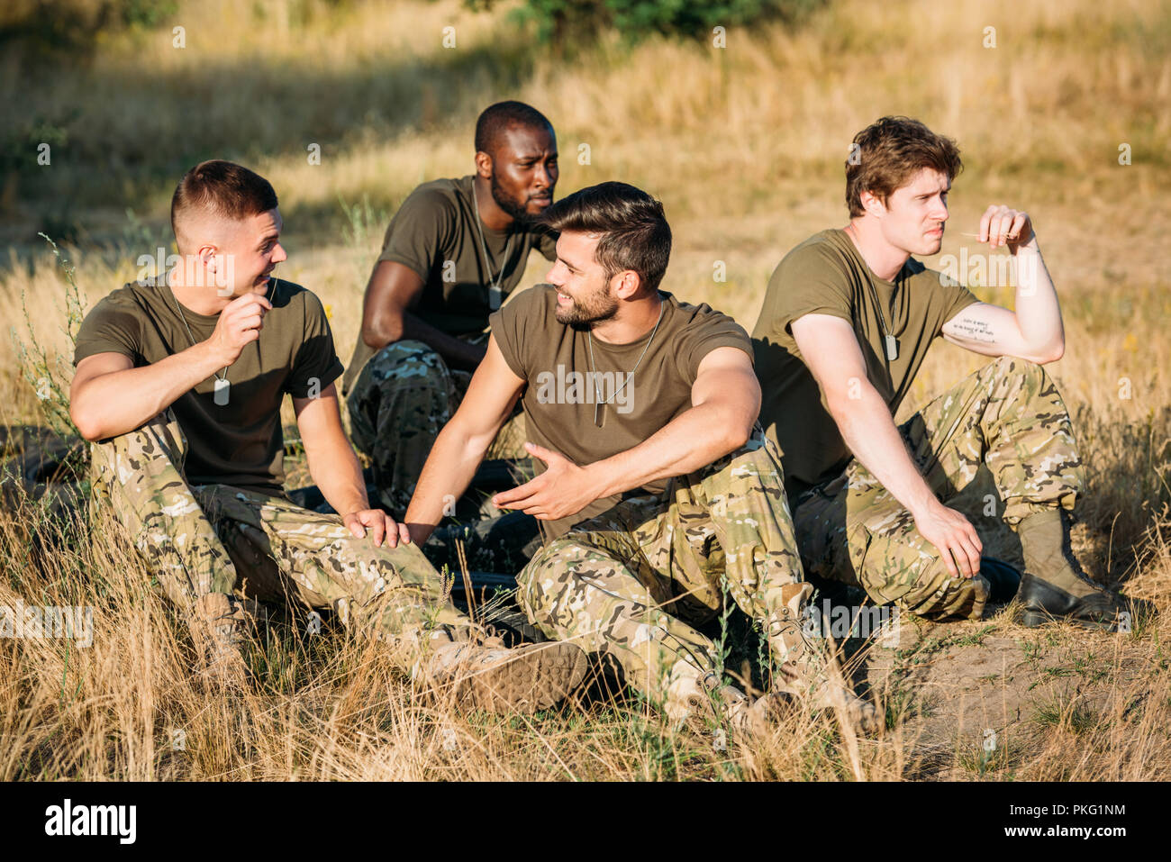 multiracial young soldiers in military uniform resting on range Stock ...