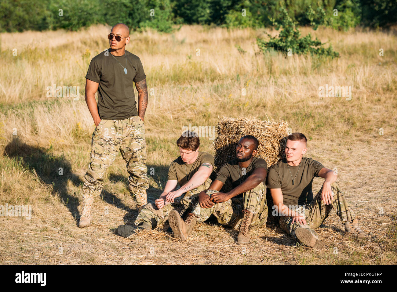 multiracial young soldiers in military uniform resting on range Stock ...