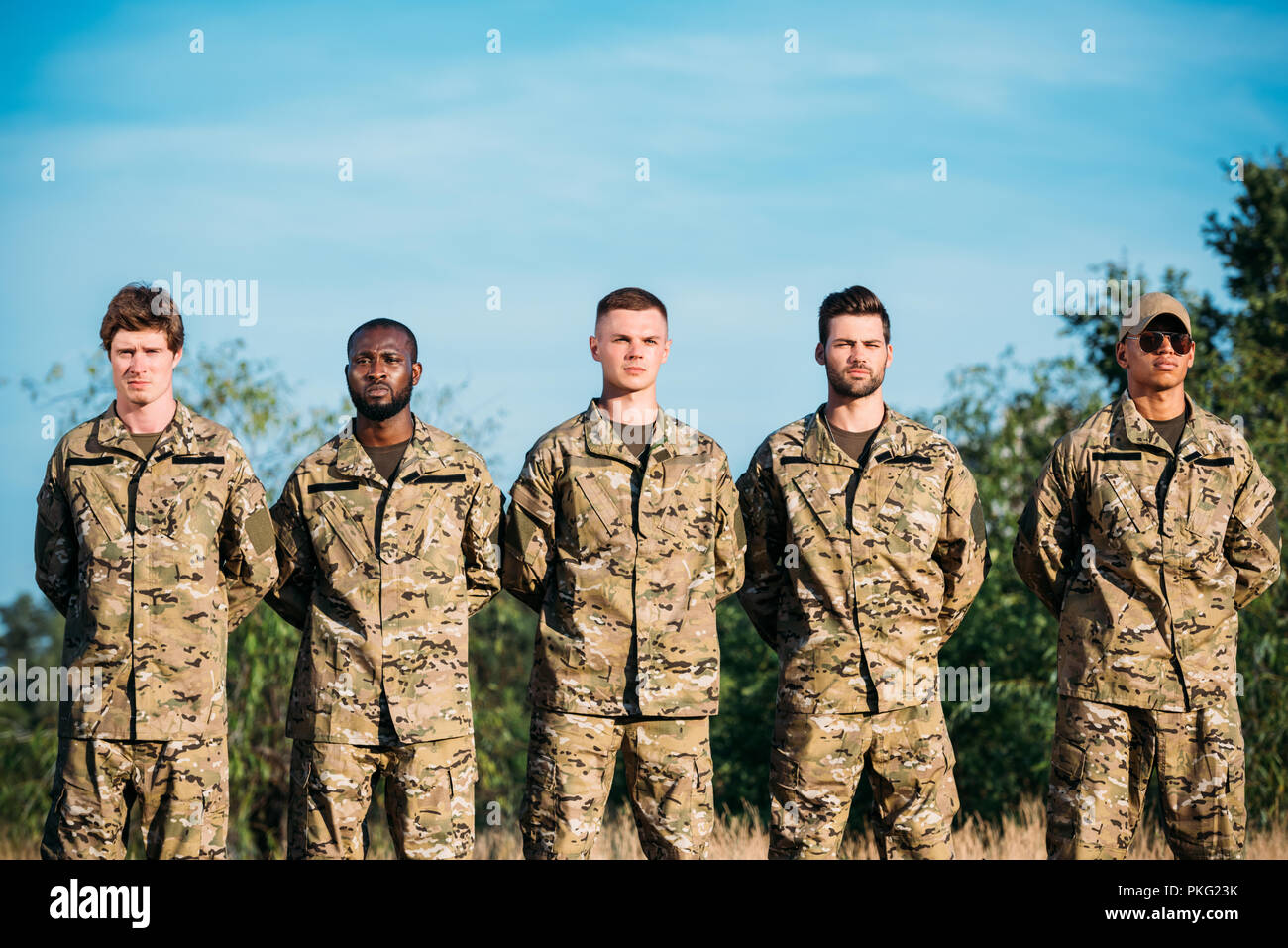portrait of multiracial confident soldiers in military uniform standing ...
