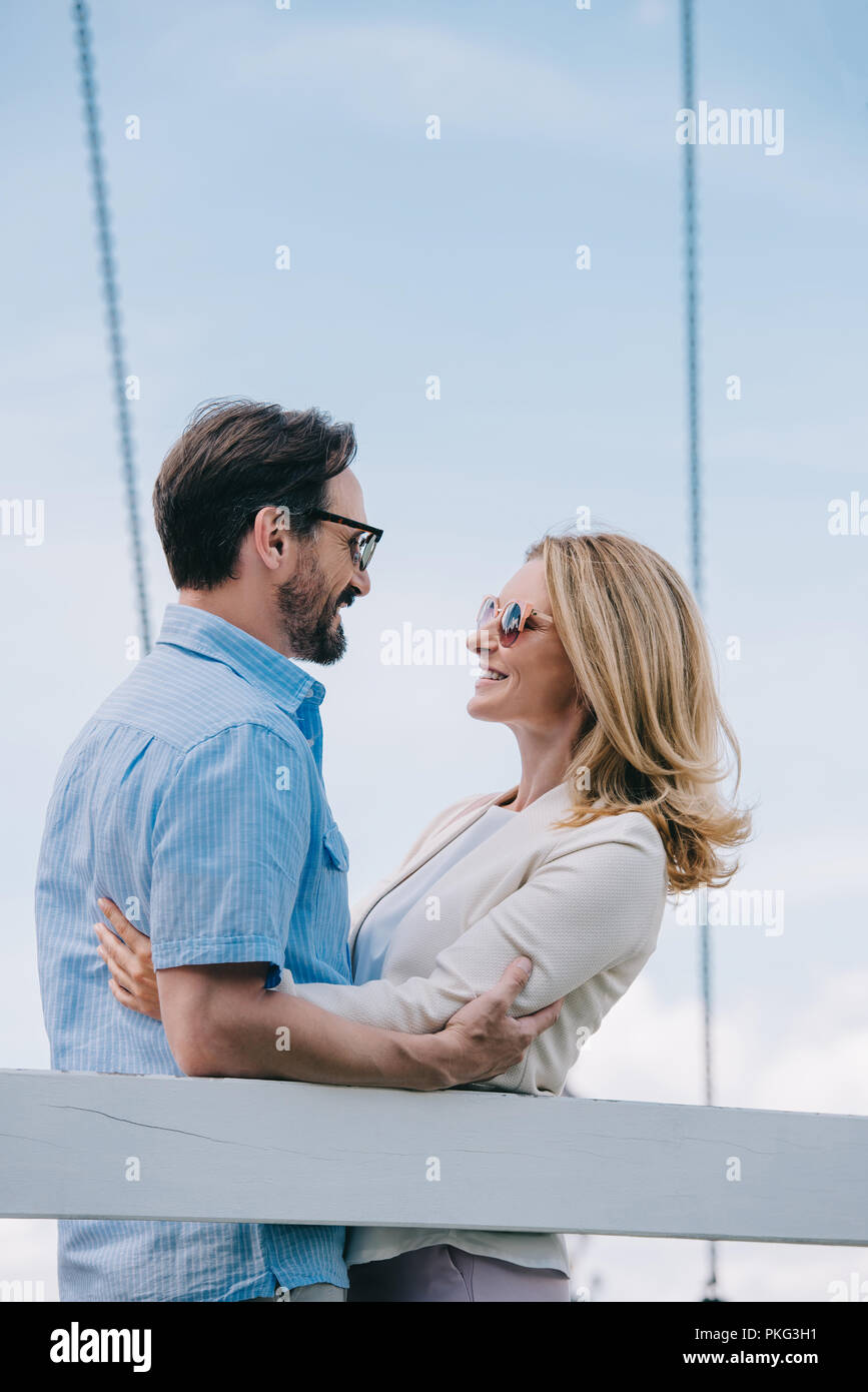 side view of adult couple hugging on street Stock Photo - Alamy